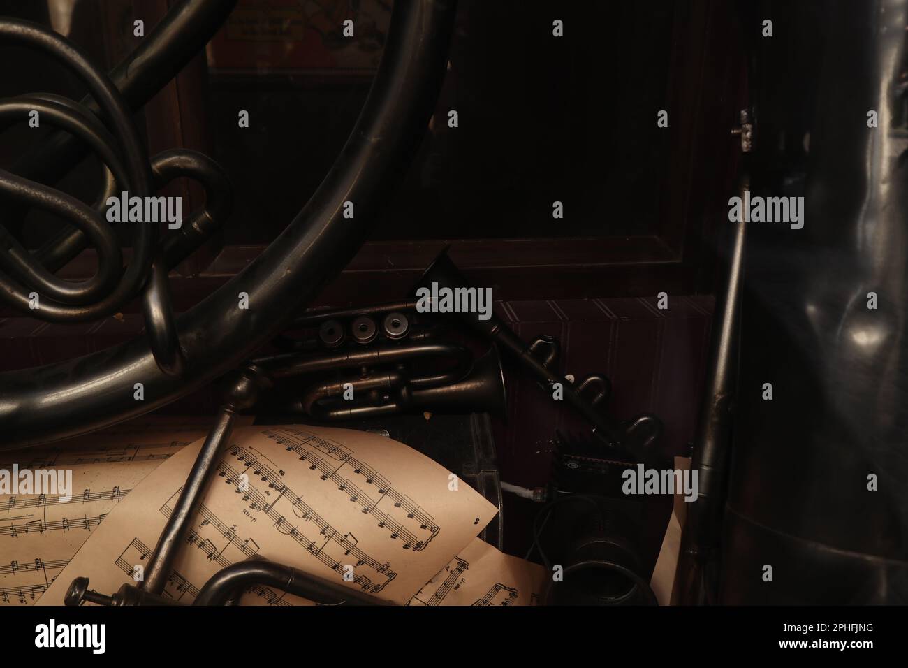 An organized array of sheet music placed on top of a wooden desk ...