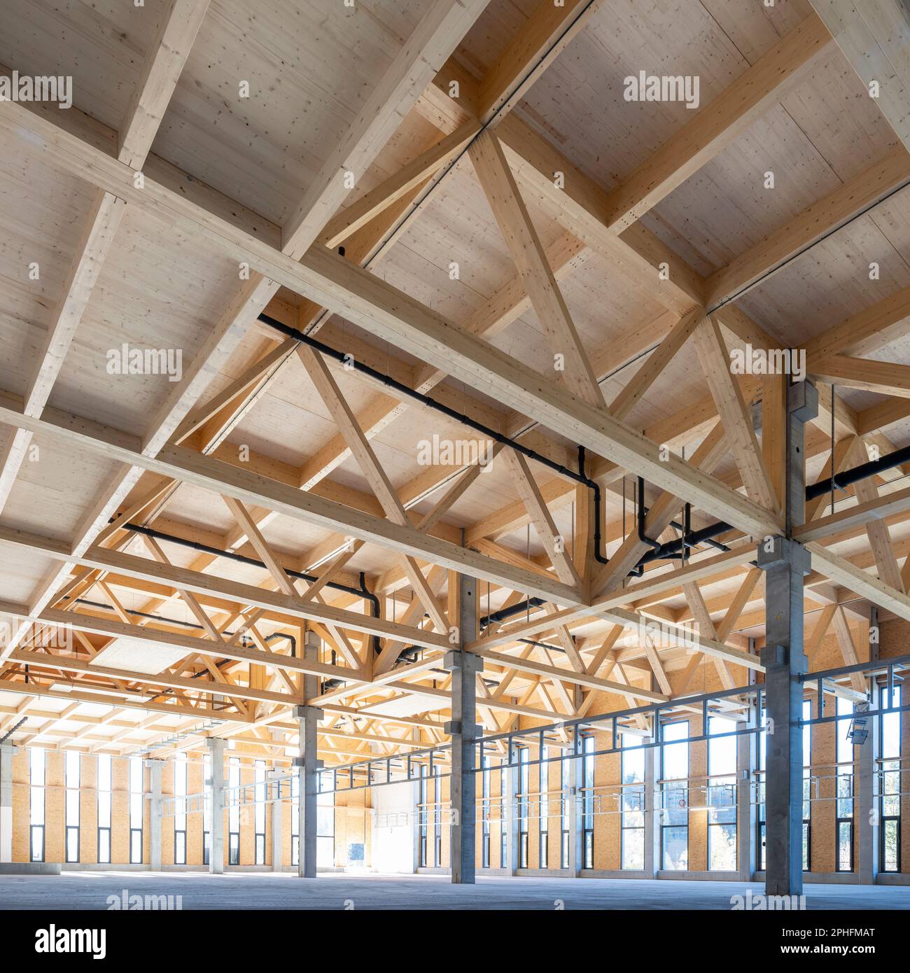 modern industrial hall with timber trusses and prefabricated concrete ...