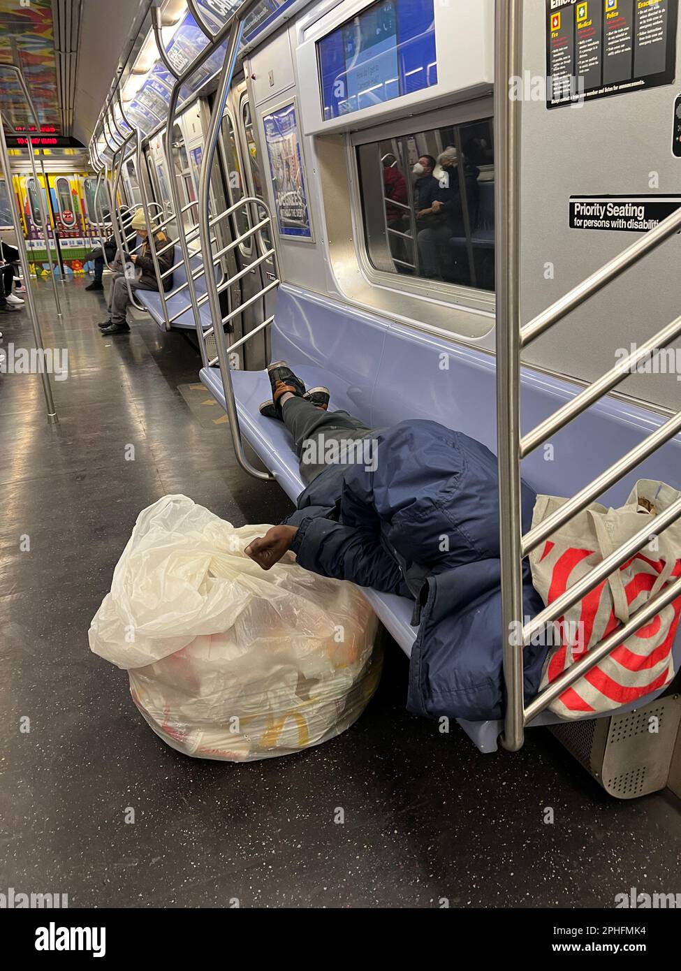 Homeless man with a bag of collected aluminum and plastic bottles and ...