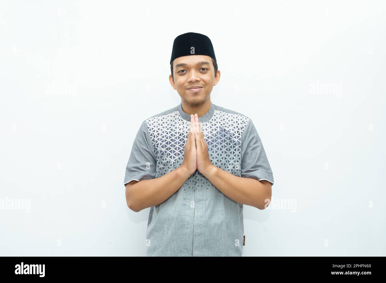 Portrait of an Asian Indonesian Muslim man placing his hands in front ...