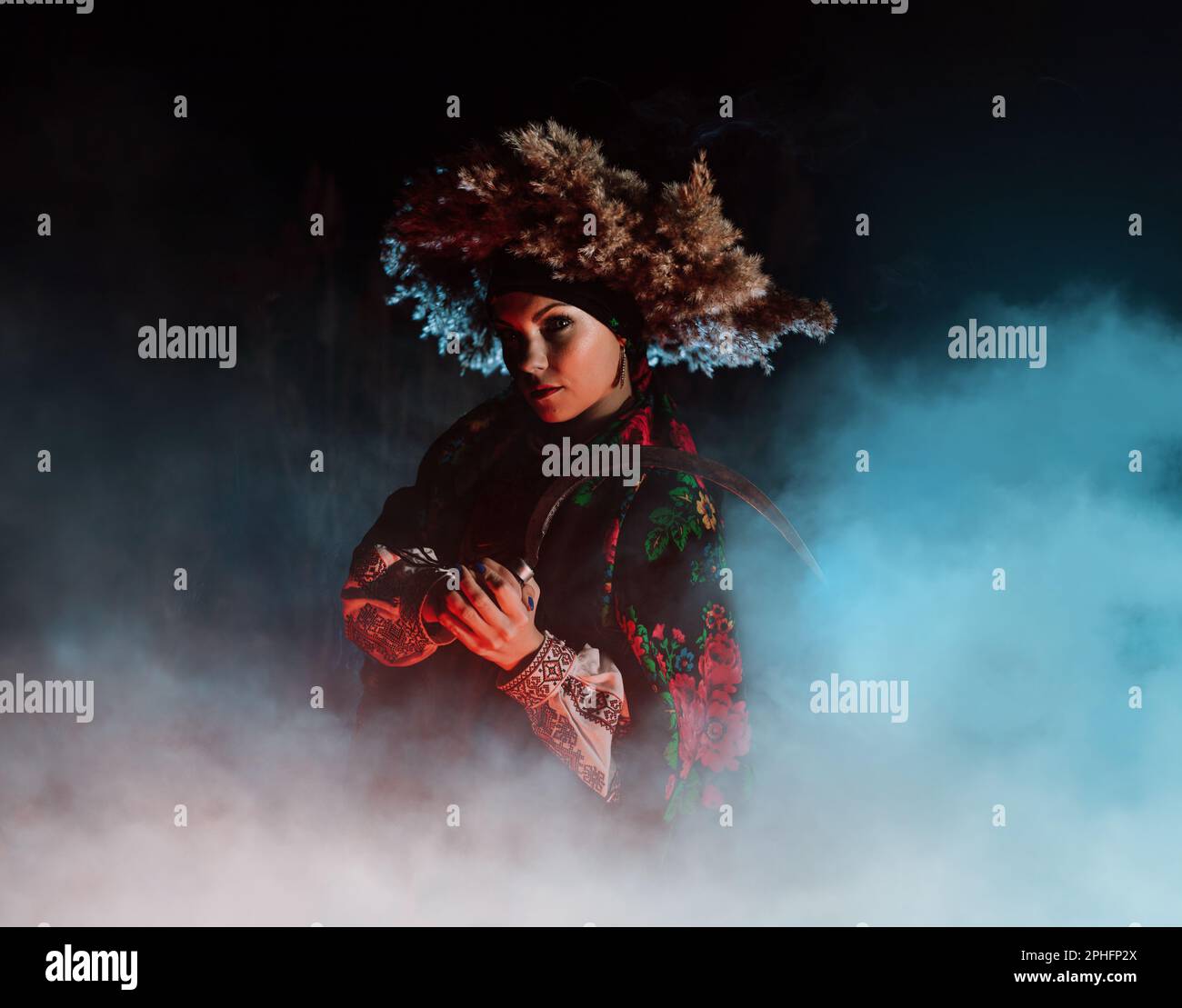 Ukrainian witch - woman in traditional costume with sickle in reeds at ...