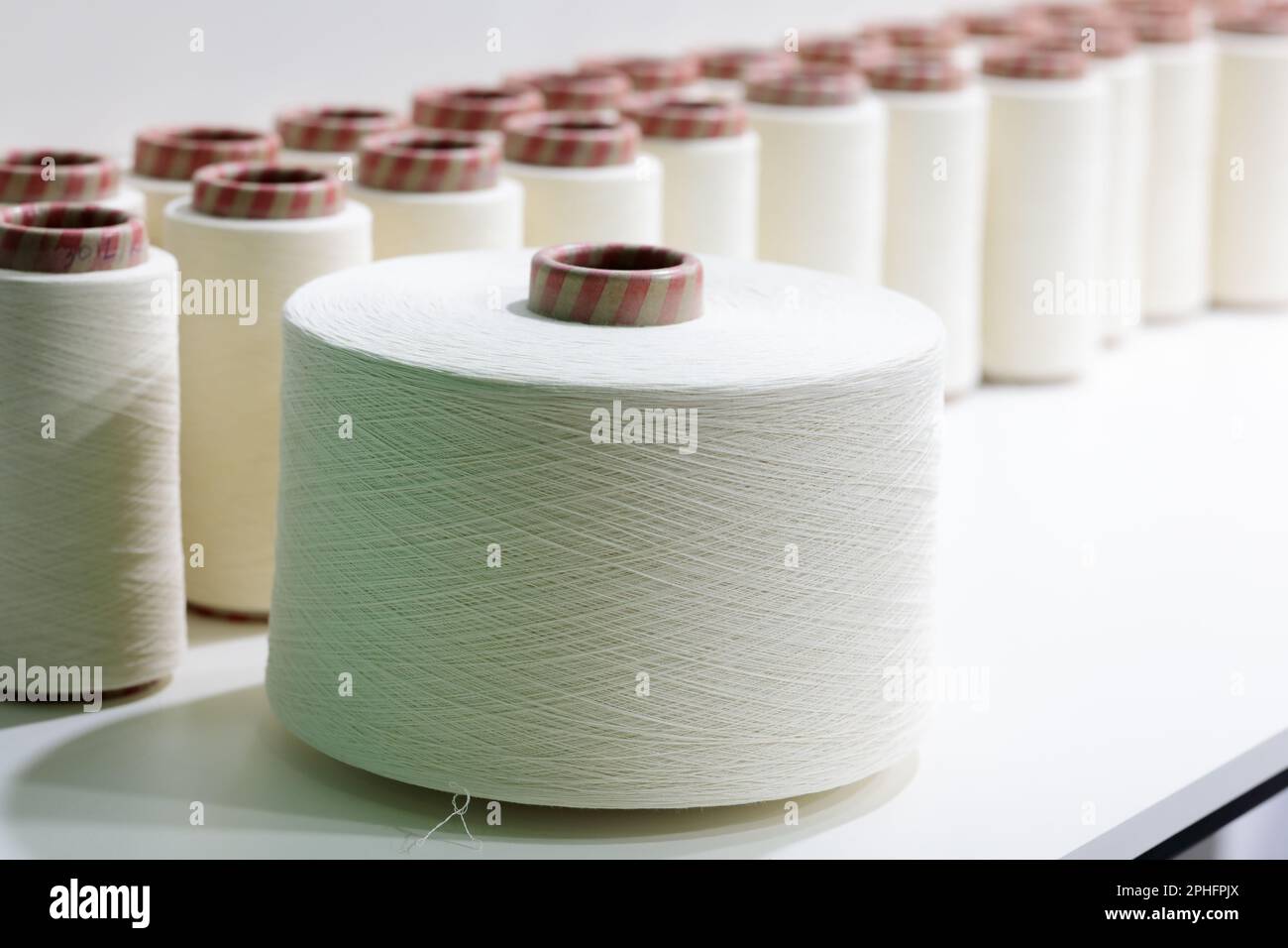 White cotton thread spools used in fabric and textile industry ...
