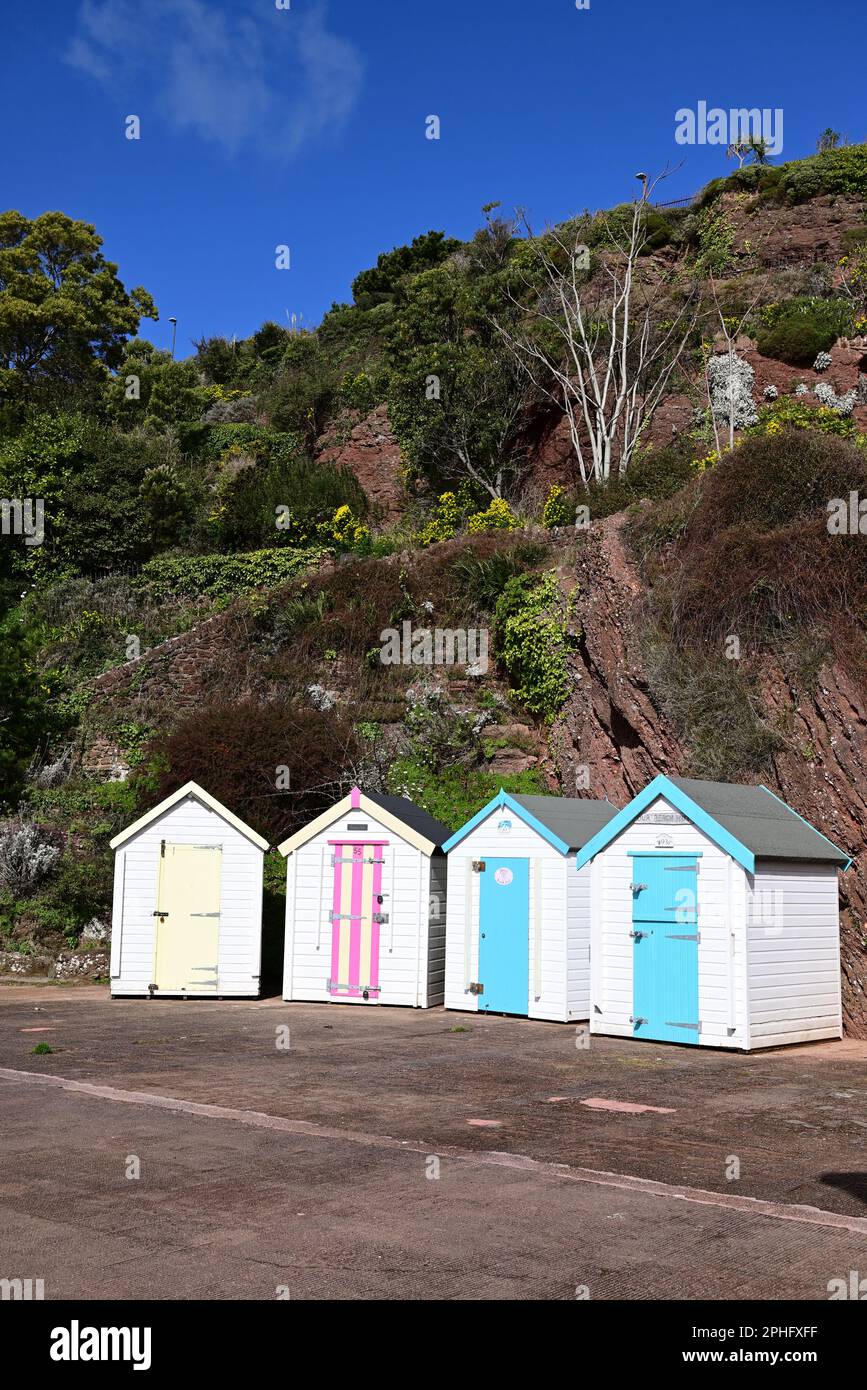 Beach huts beneath Roundham Head, on the seafront at Goodrington Sands ...