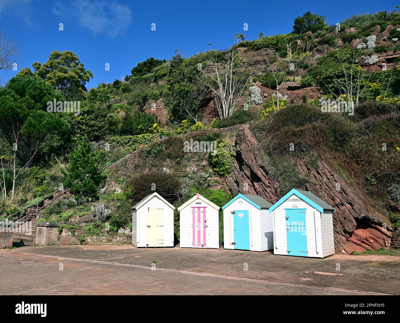 Beach huts beneath Roundham Head, on the seafront at Goodrington Sands ...