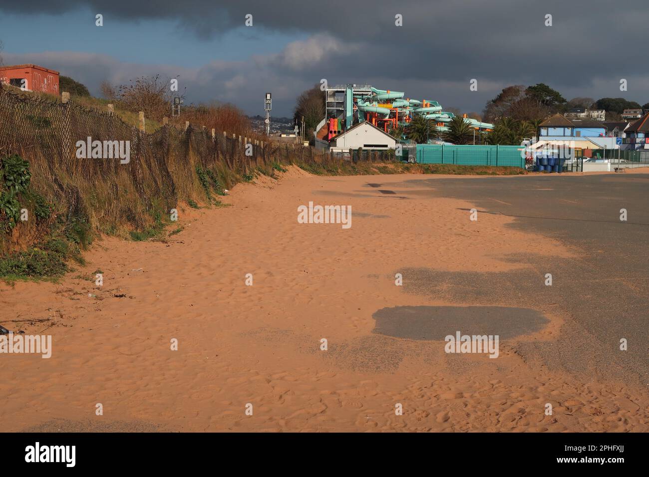 Winter sunlight and windblown sand piled up against a wall on the ...