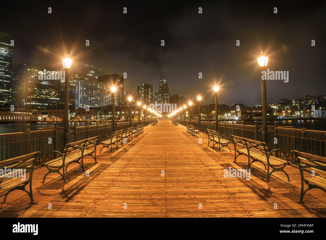 Deserted wooden Pier seven lined with street lights and benches in San ...