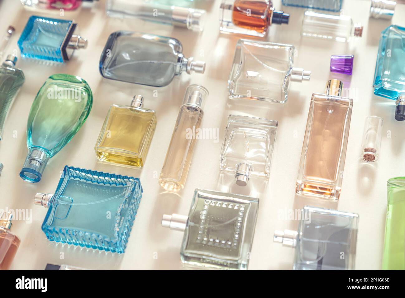 Perfumery, cosmetics and beauty industry background. A lot of transparent bottles of perfume and ...