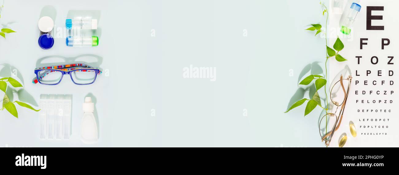 Eye care banner with eyeglasses, containers with contact lenses ...