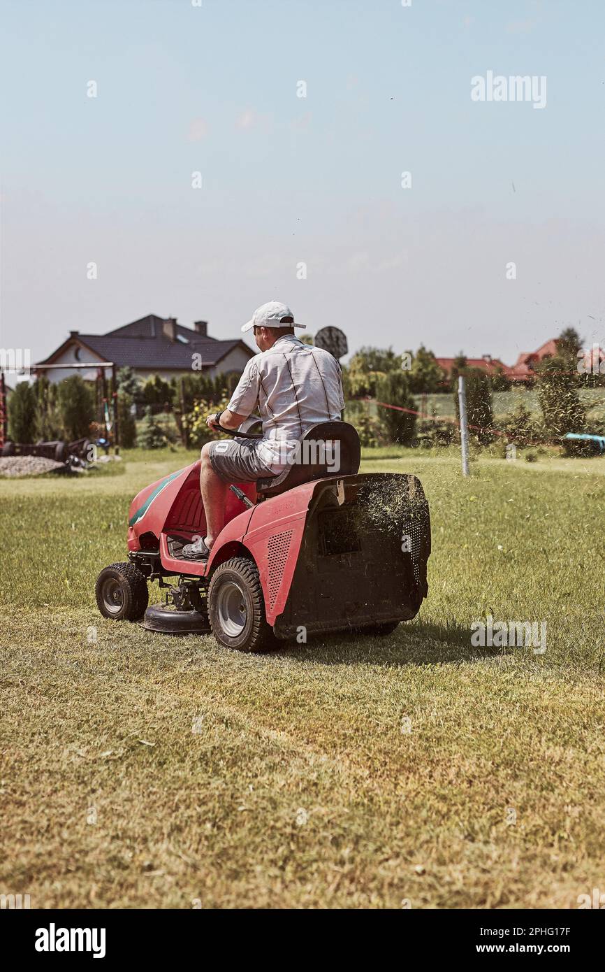 Maintenance man riding tractor hi-res stock photography and images - Alamy