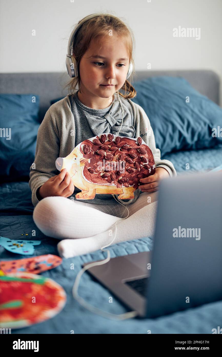 Little girl preschooler learning online showing her works drawings done ...