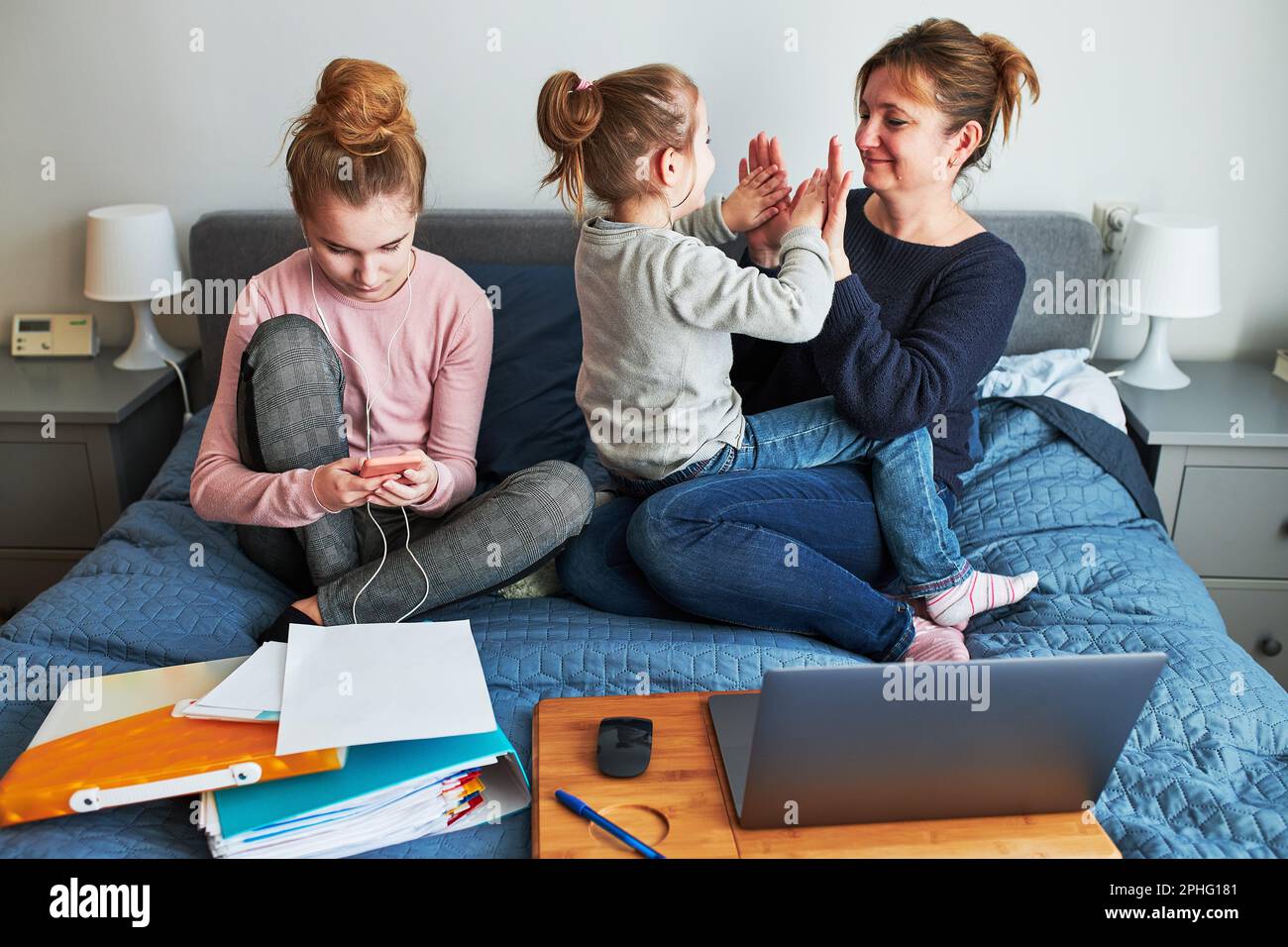 Mother taking a break in work to play with her little daughter. Women ...