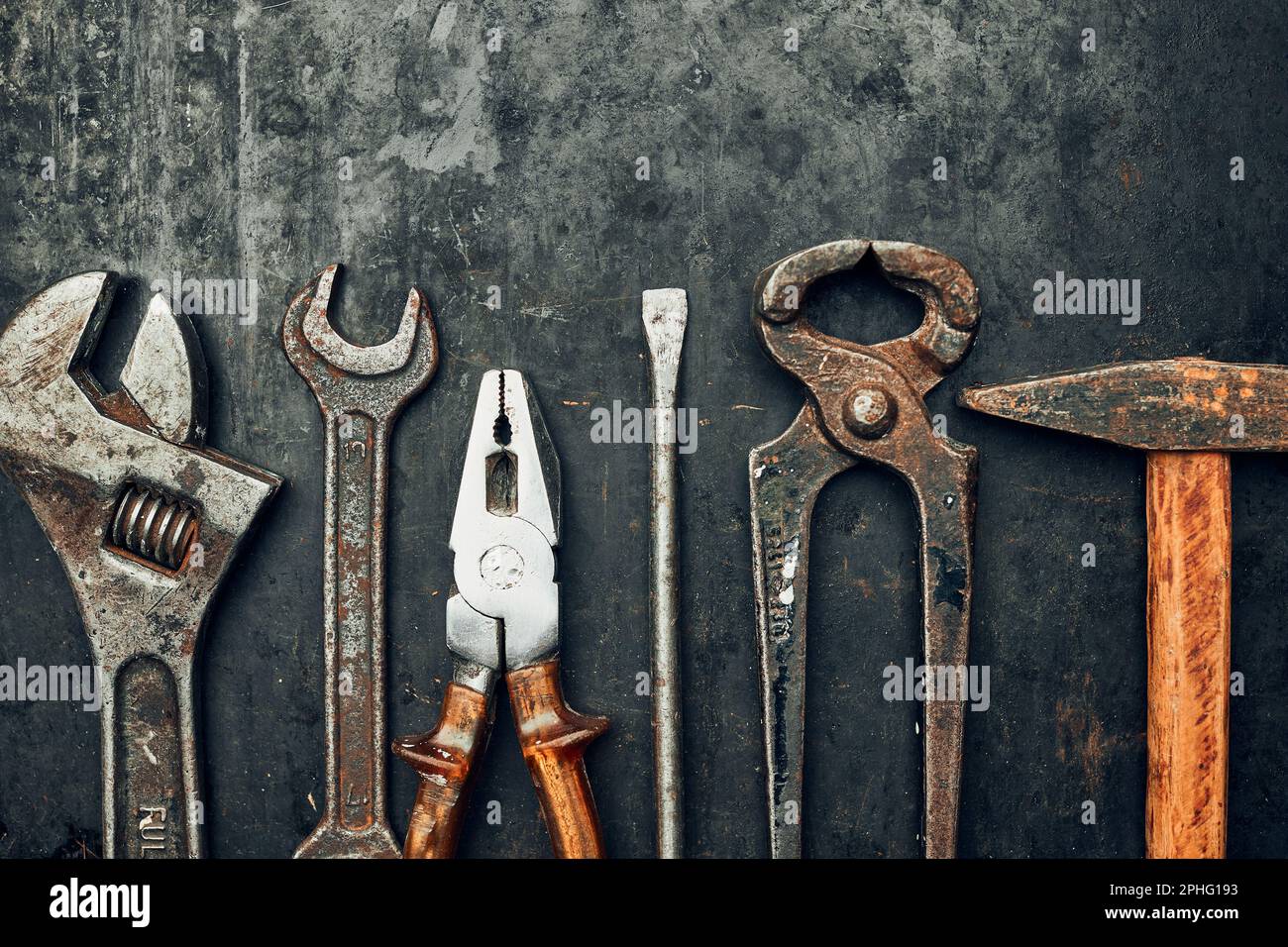 Old hardware tools. Wrench, screwdriver, measure, hammer, pliers on ...