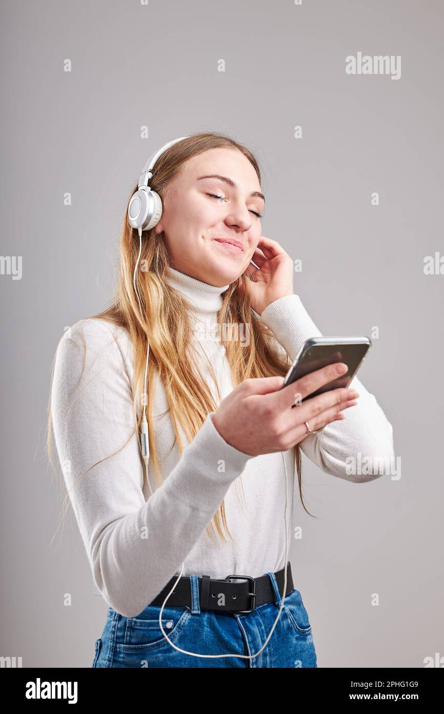 Young woman girl listening to music streaming content having fun ...