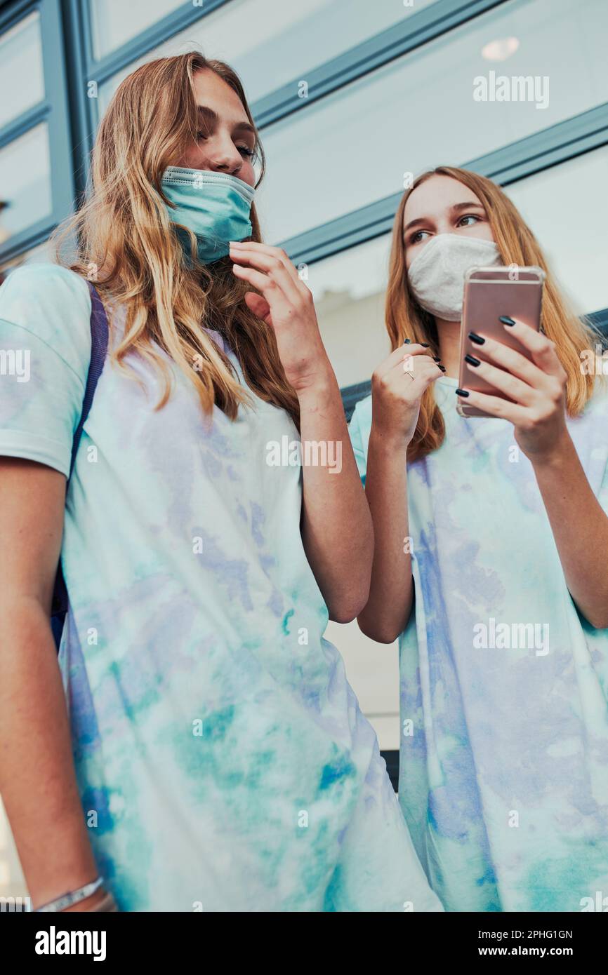 Young women girls using smartphones using social media sending texts ...