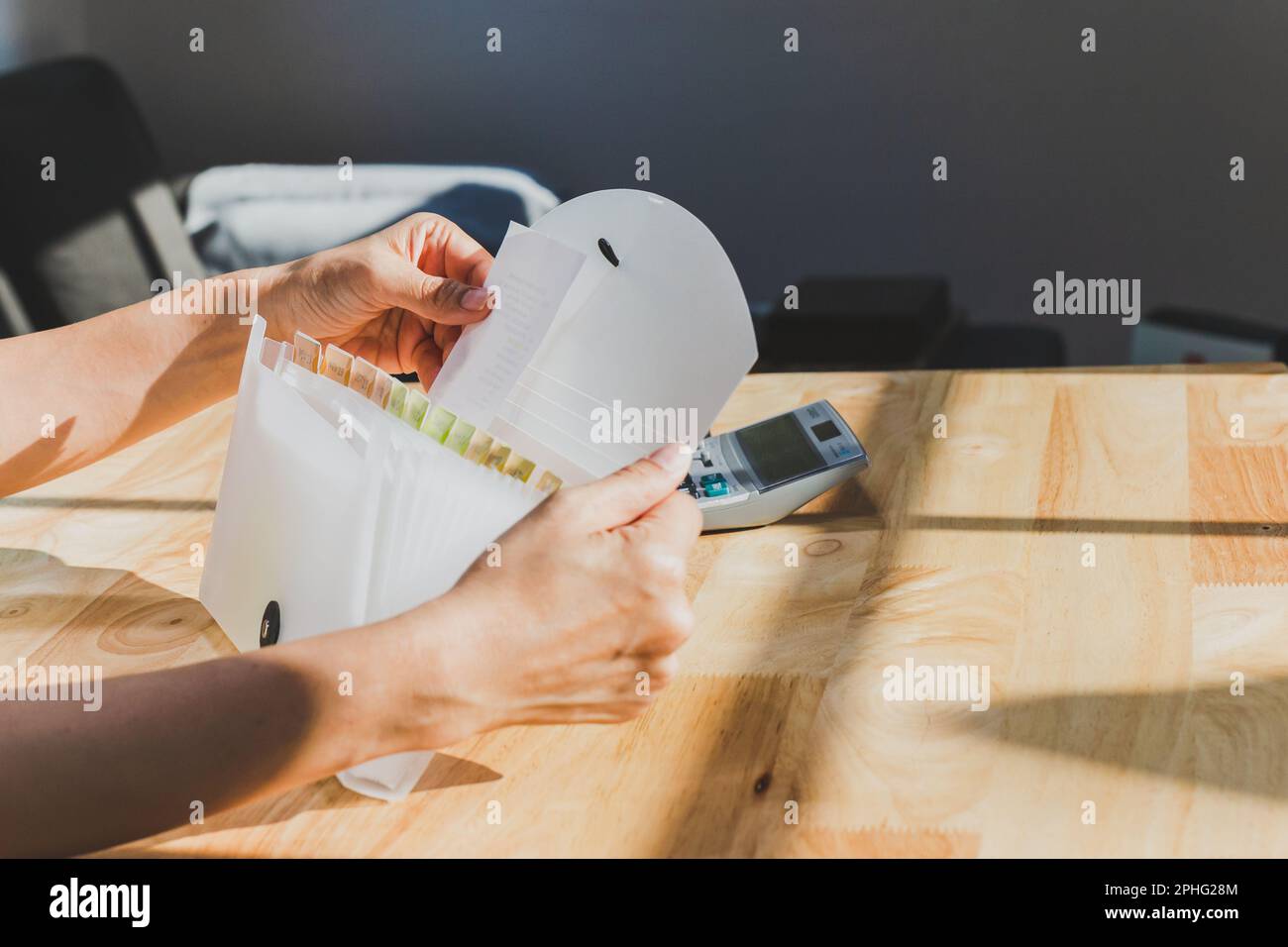 Woman hands organizing folder on a desk at home Stock Photo - Alamy