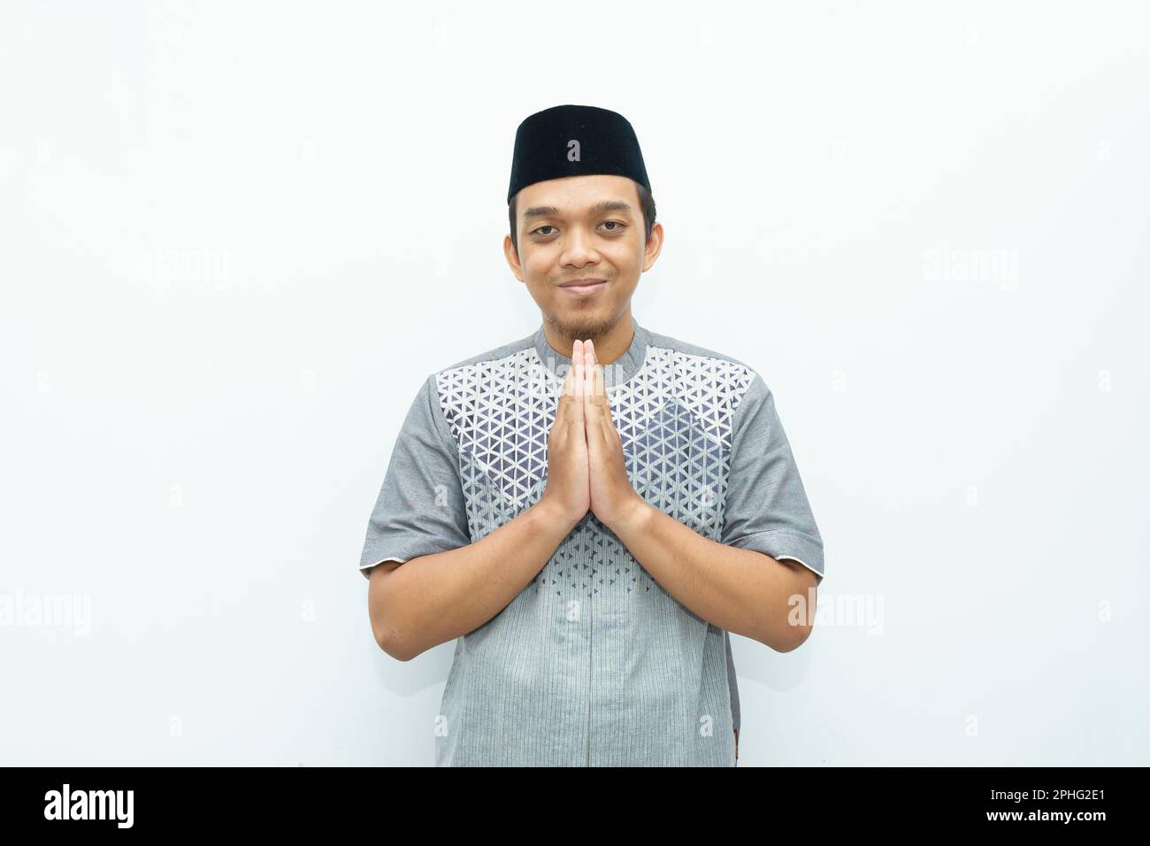 Portrait of an Asian Indonesian Muslim man placing his hands in front ...