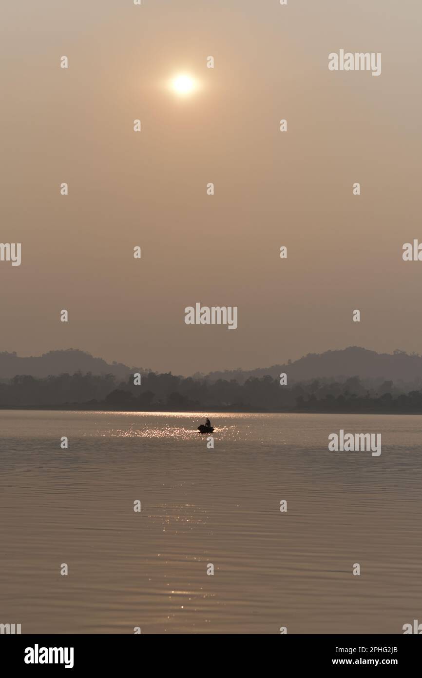 Sunset in lake Dumboor of Tripura . With one boat and reflection of the ...