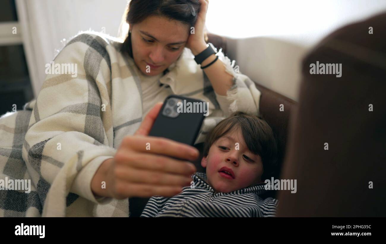 Mother holding phone for child to speak with family member on video ...