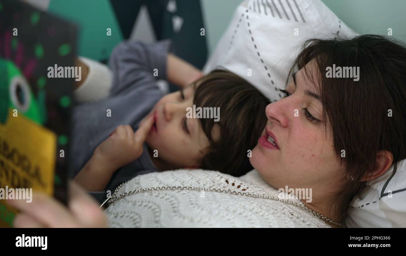 Mother telling a bedtime story to son. Child night routine before sleep ...