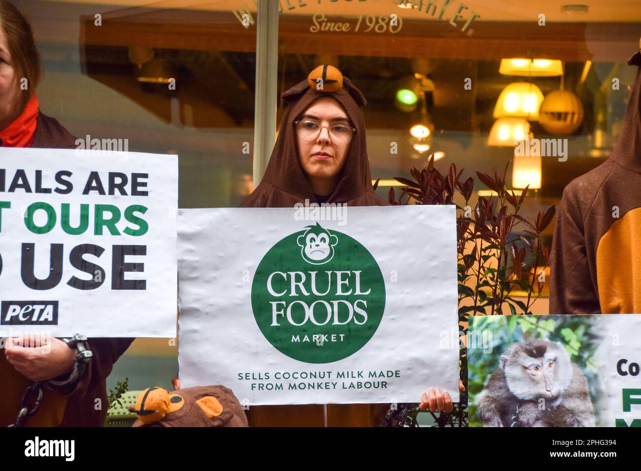 London, UK. 28th Mar, 2023. An activist holds a placard which states ...