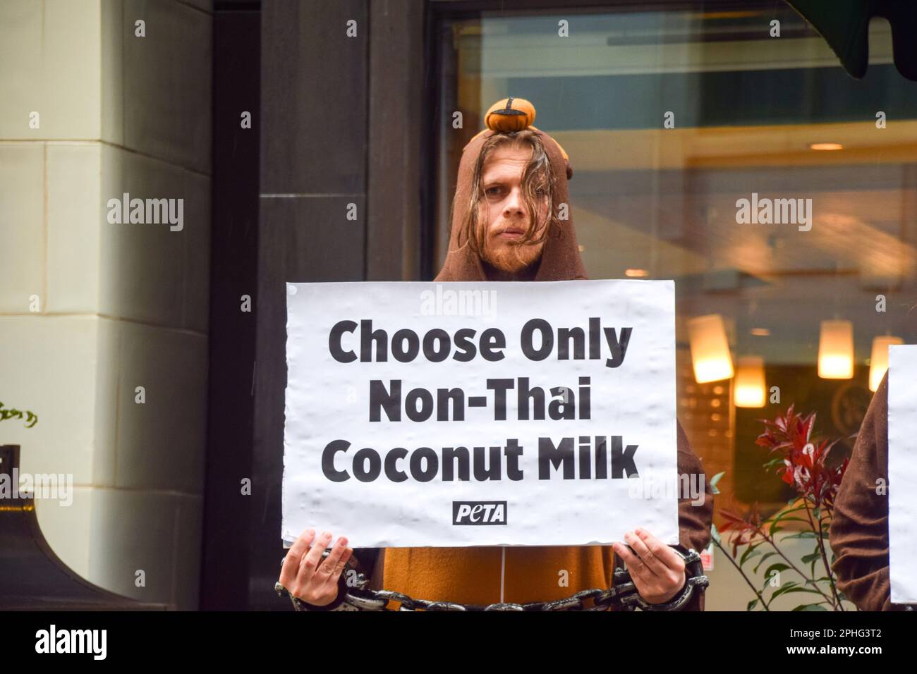 London, UK. 28th Mar, 2023. An activist holds a placard which states ...