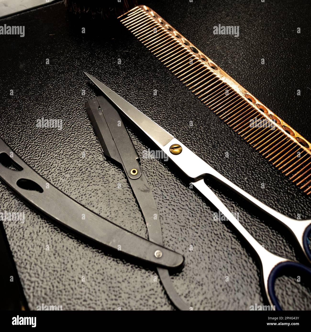 Scissors, comb and razor on barber's work table Stock Photo - Alamy
