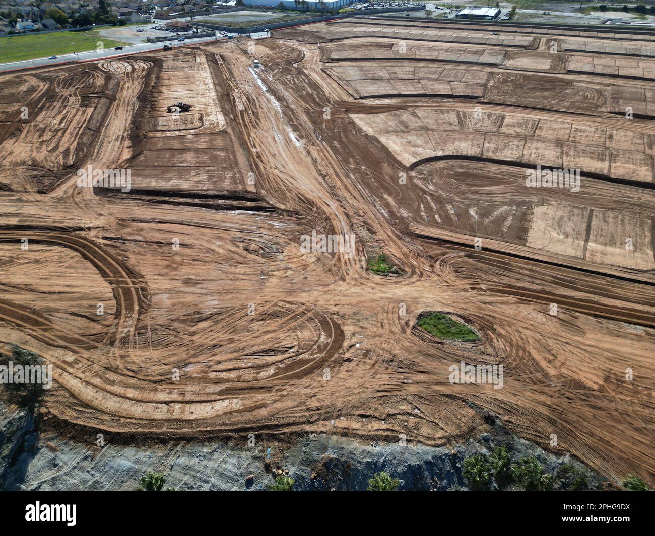 An aerial view of a construction site featuring a large dirt field ...