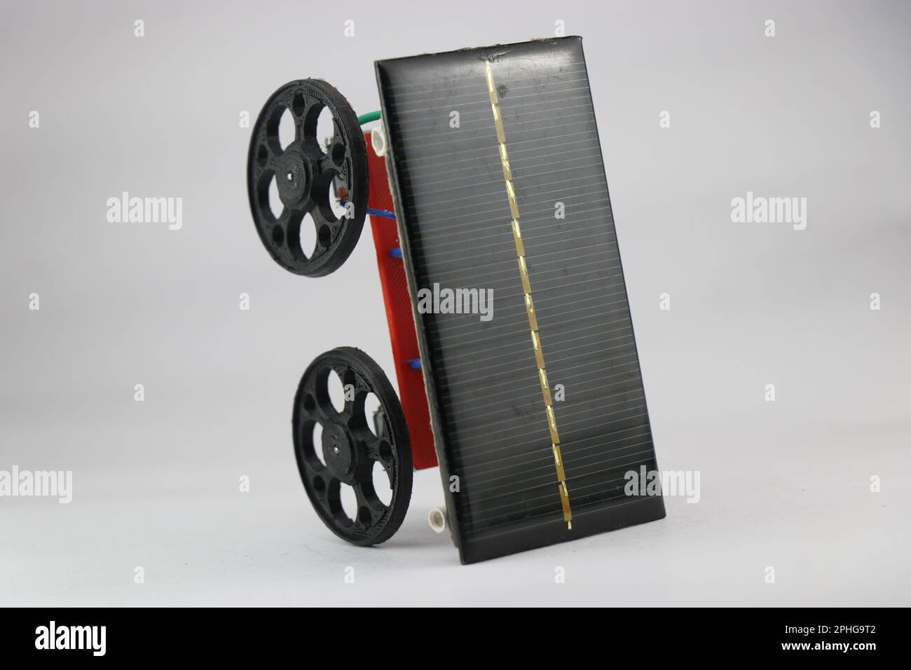 Solar powered car with a view of its solar panel and wheels on a white ...