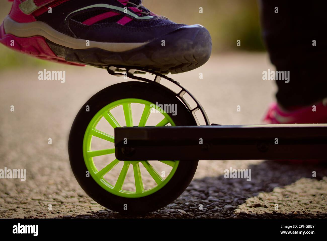 Braking to a Halt: Close-up of a Little Girl's Shoe Pressing the Rear ...