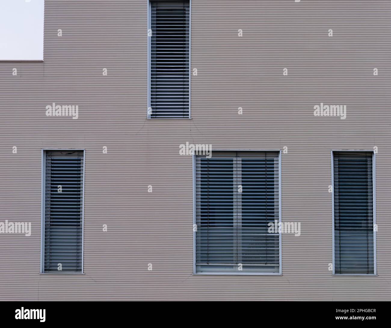A grayish-brown textured wall with window blinds Stock Photo - Alamy