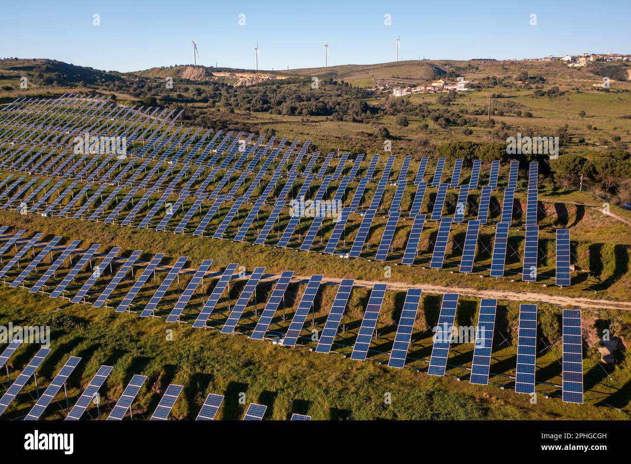 Long rows of photovoltaic panels at solar farm for converting energy of ...