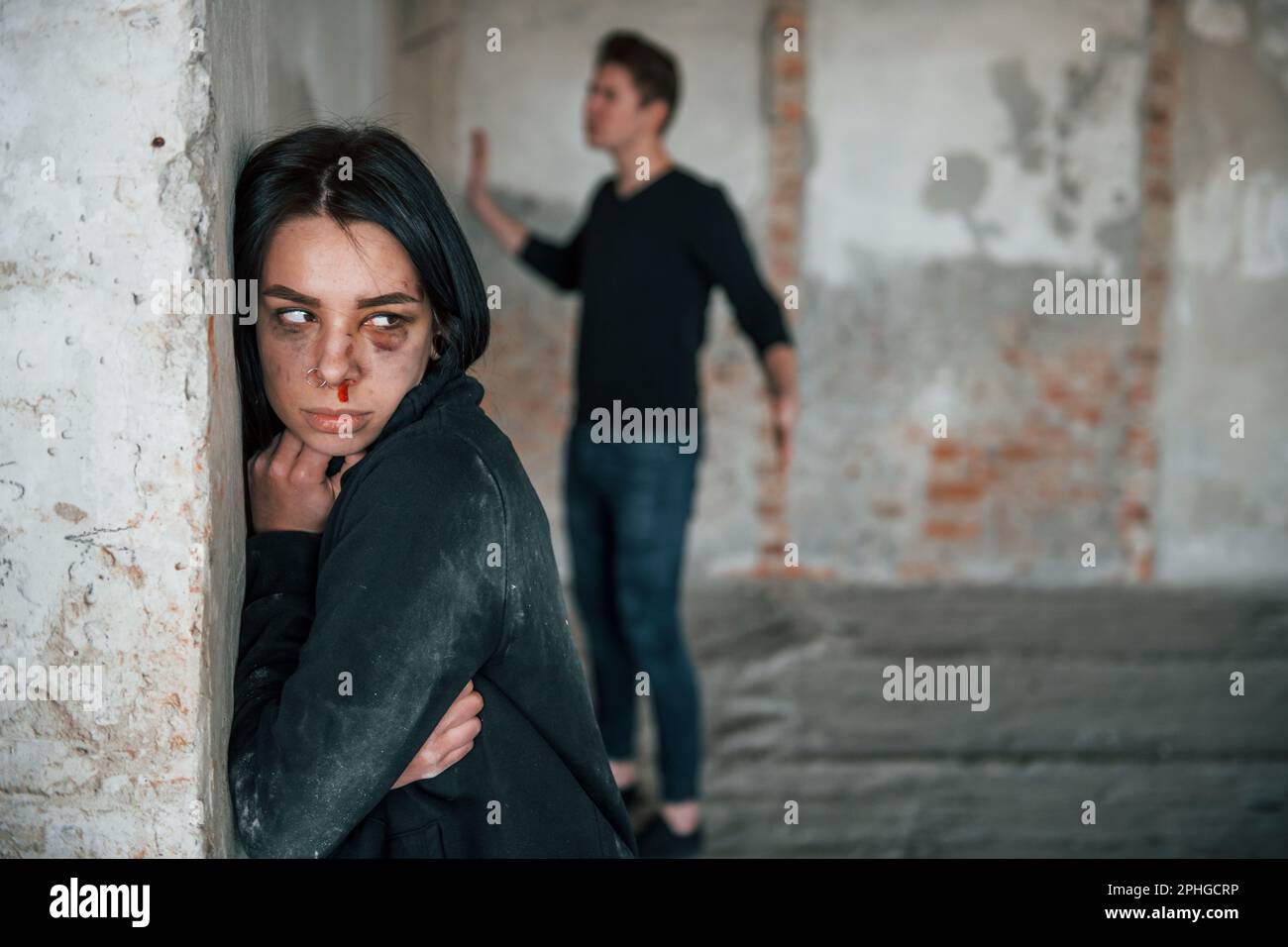 Kidnapped woman is threatened by man in abandoned building Stock Photo ...