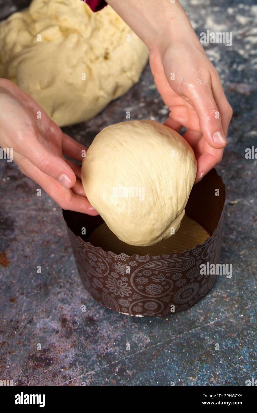 The confectioner girl prepares the dough for baking Easter cakes and ...