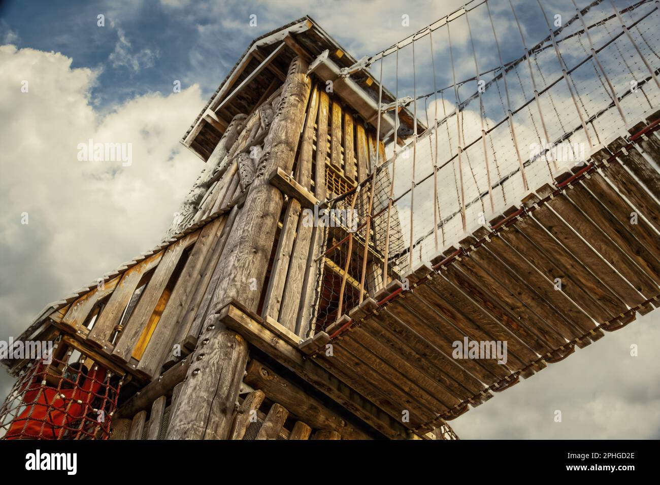 Wooden climbing tower with Net climbing mesh on bridge to another tower ...