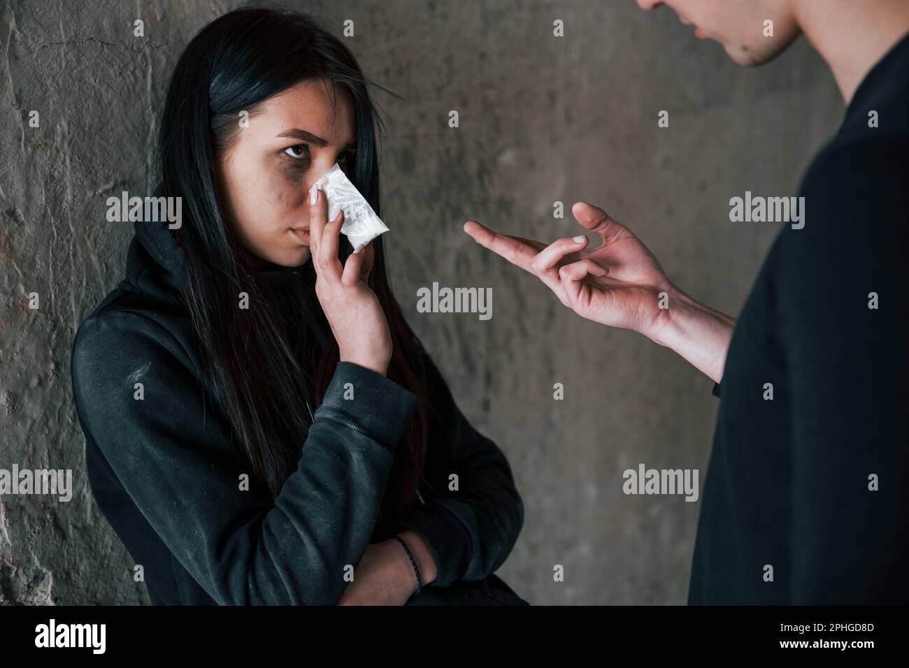 Two people standing with illegal drugs in little package indoors Stock ...