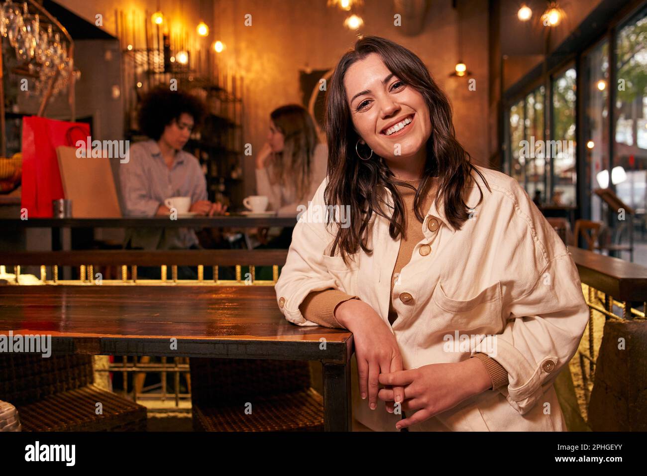 Copy space portrait of cheerful girl leaning on bar table. Woman poses ...