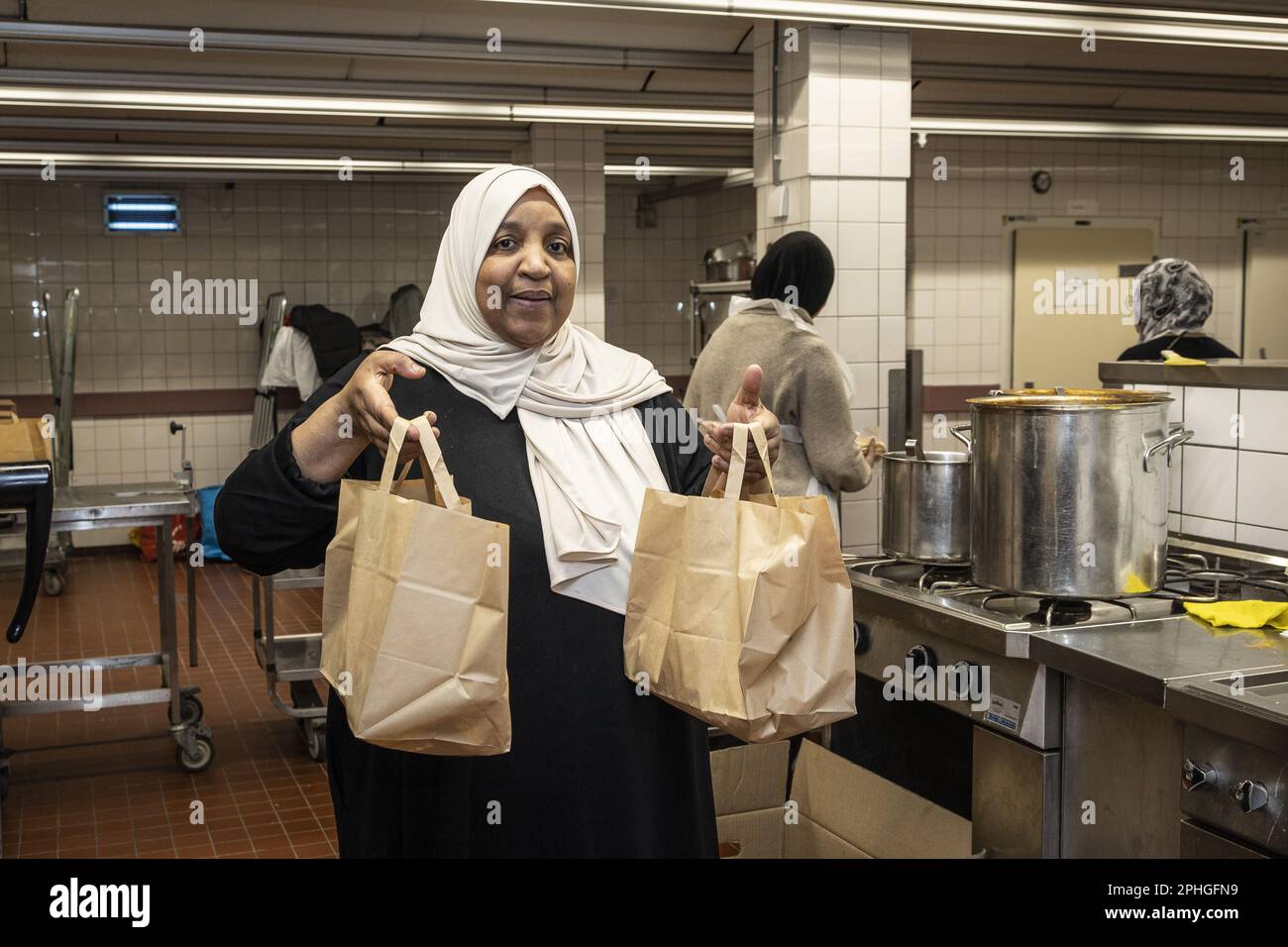 AMSTERDAM - Volunteers hand out healthy packages for the iftar in a ...