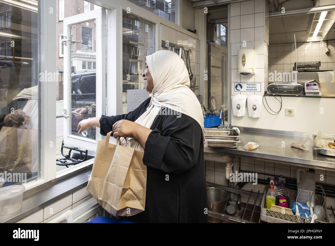AMSTERDAM - Volunteers hand out healthy packages for the iftar in a ...