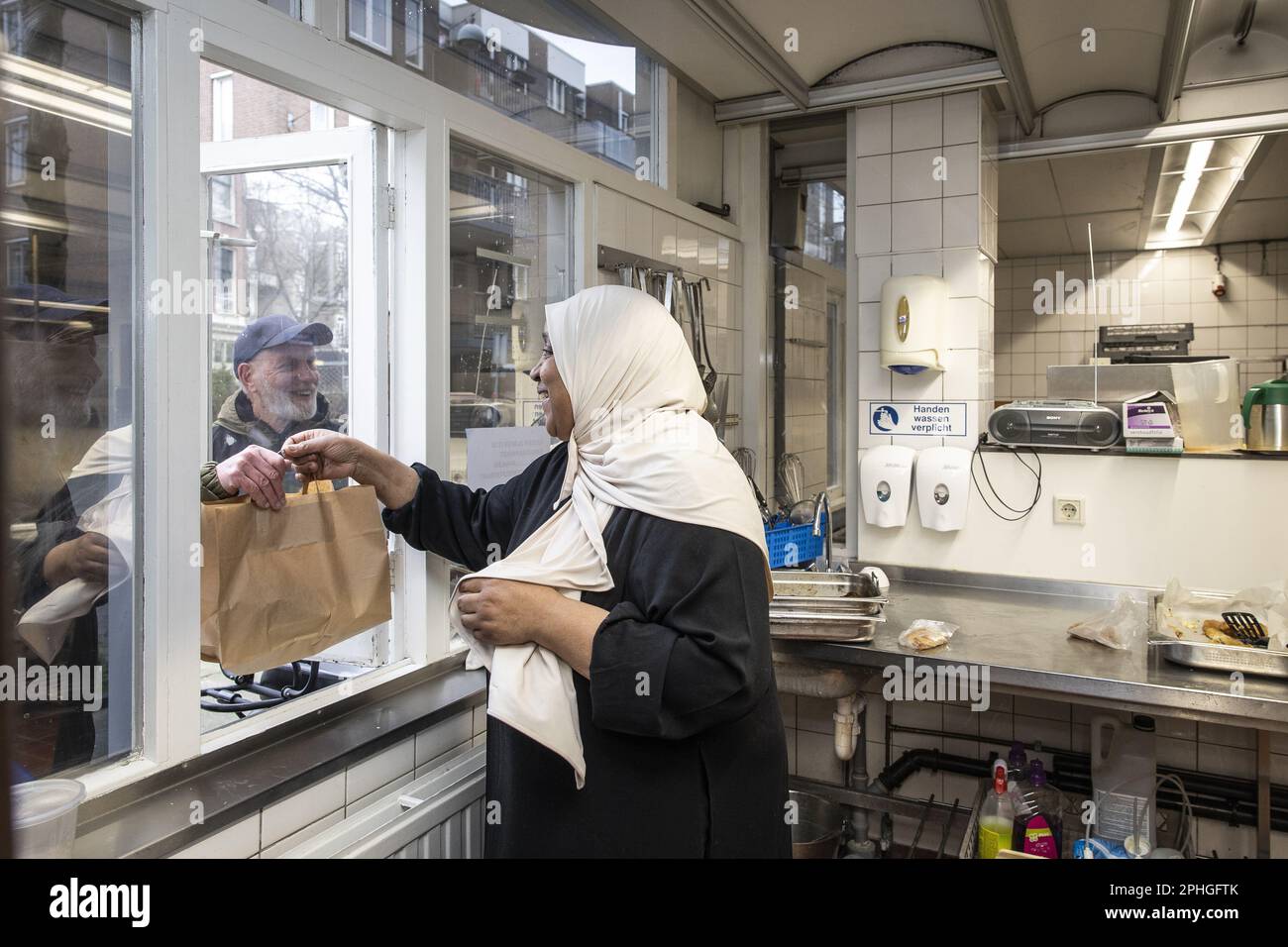 AMSTERDAM - Volunteers hand out healthy packages for the iftar in a ...