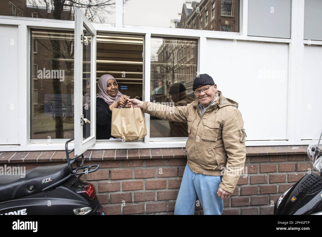 AMSTERDAM - Volunteers hand out healthy packages for the iftar in a ...