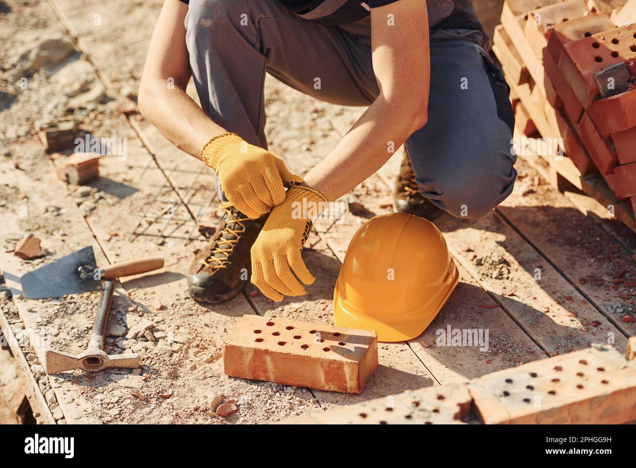 Close up view of construction worker in uniform and safety equipment ...