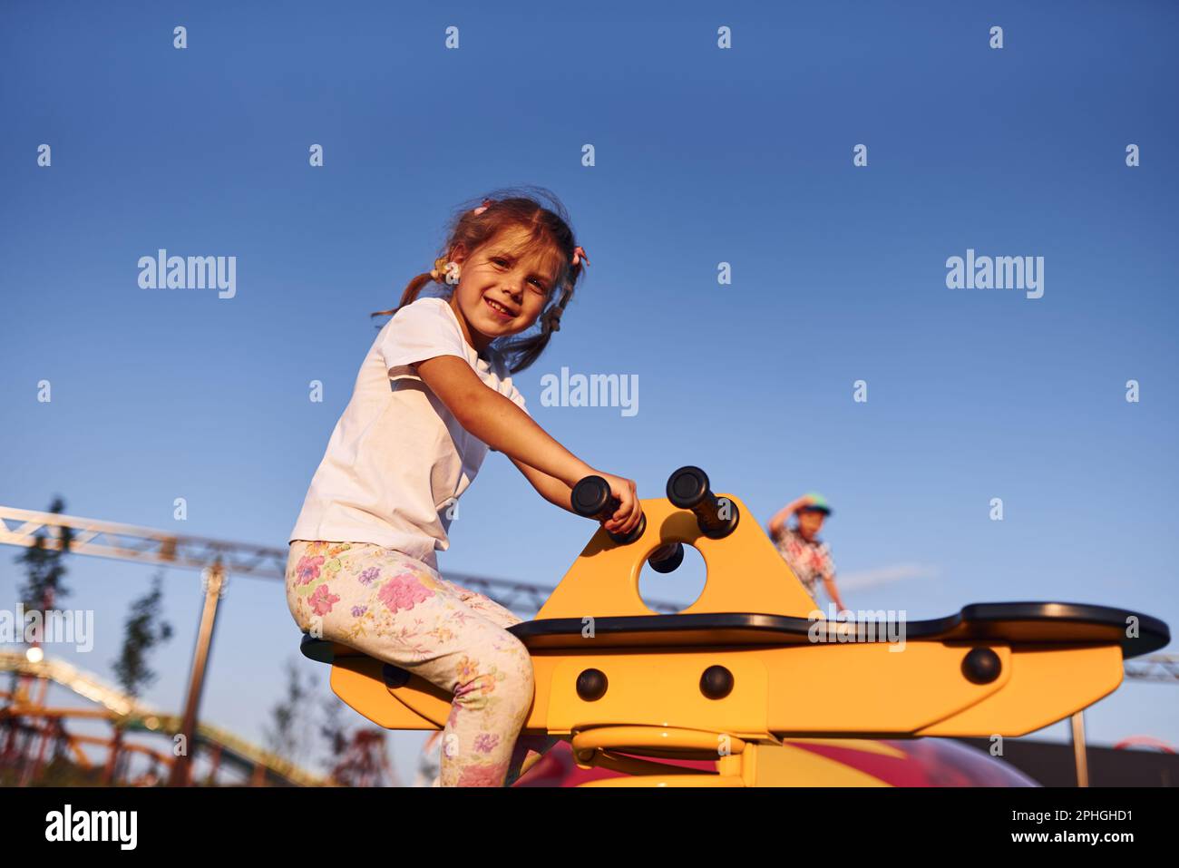 Little girl have fun at children's amusement park at daytime Stock ...