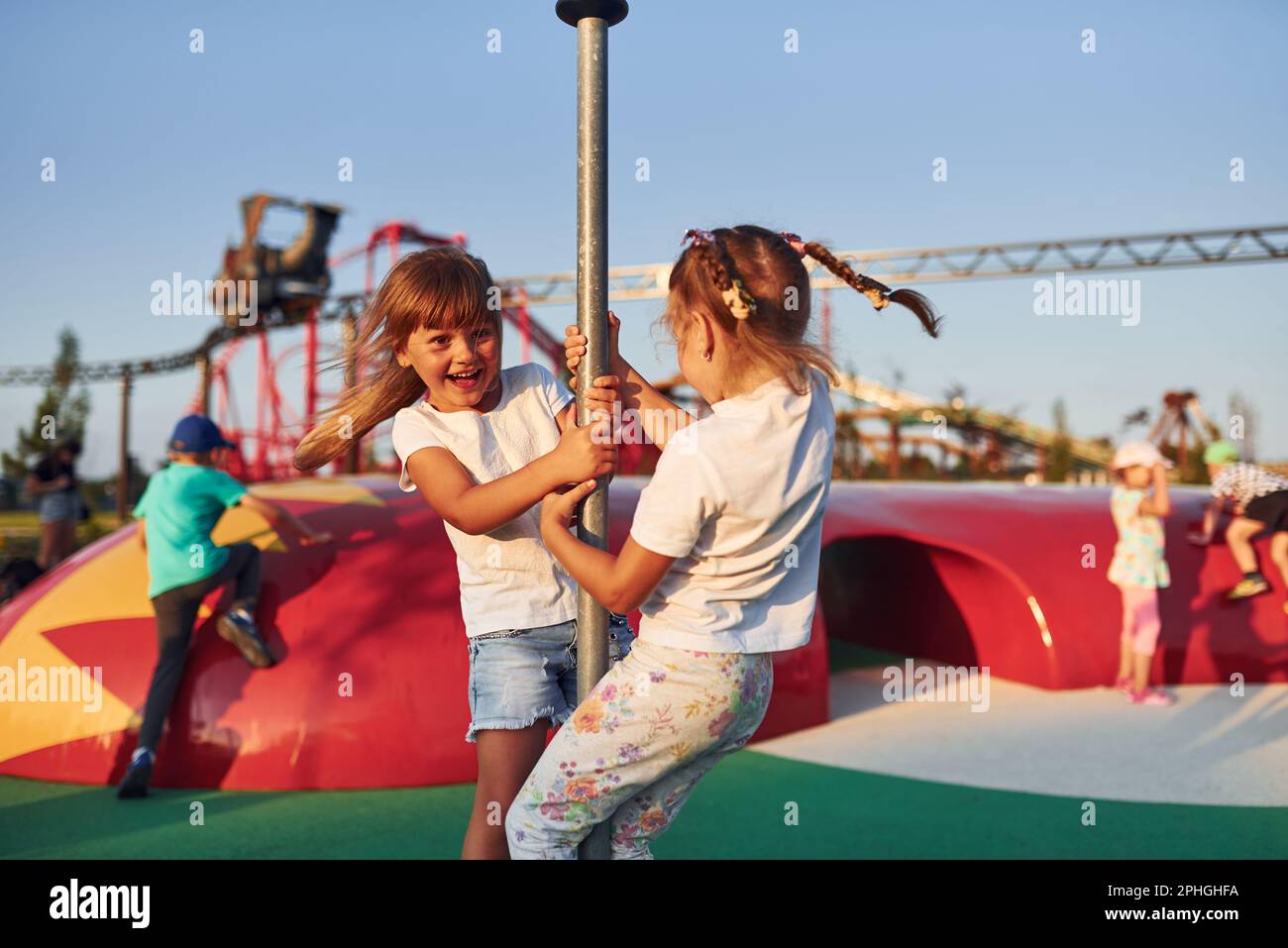 Little girls have fun at children's amusement park at daytime Stock ...