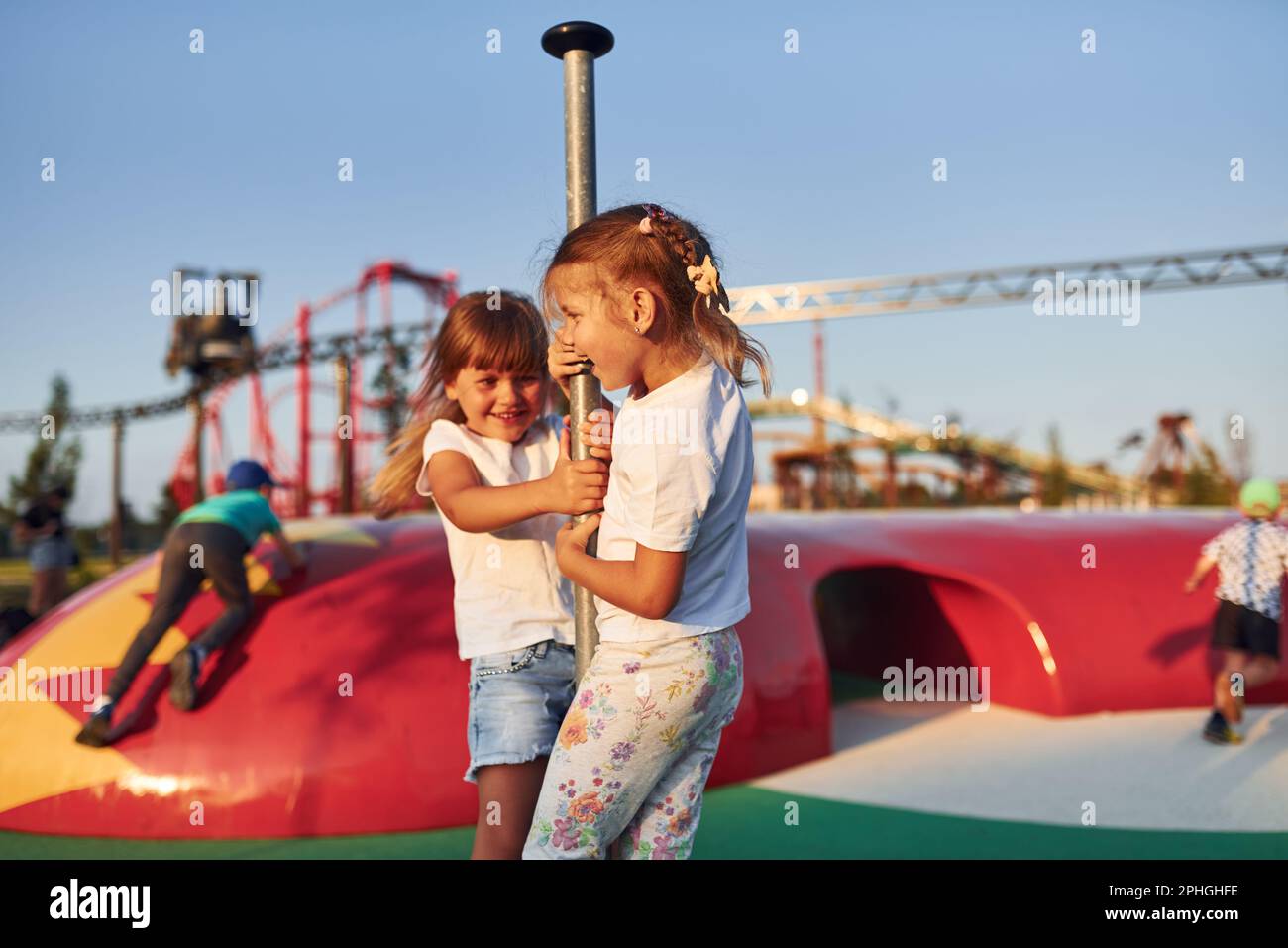 Little girls have fun at children's amusement park at daytime Stock ...