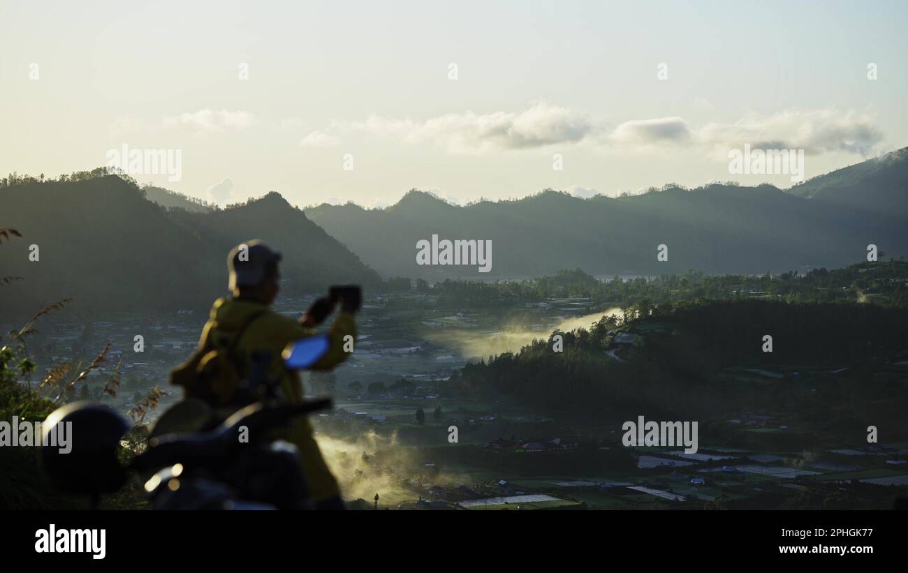 Bali, a man on a bike photographing mountains Stock Photo - Alamy Bali, a man on a bike photographing mountains Stock Photo - Alamy