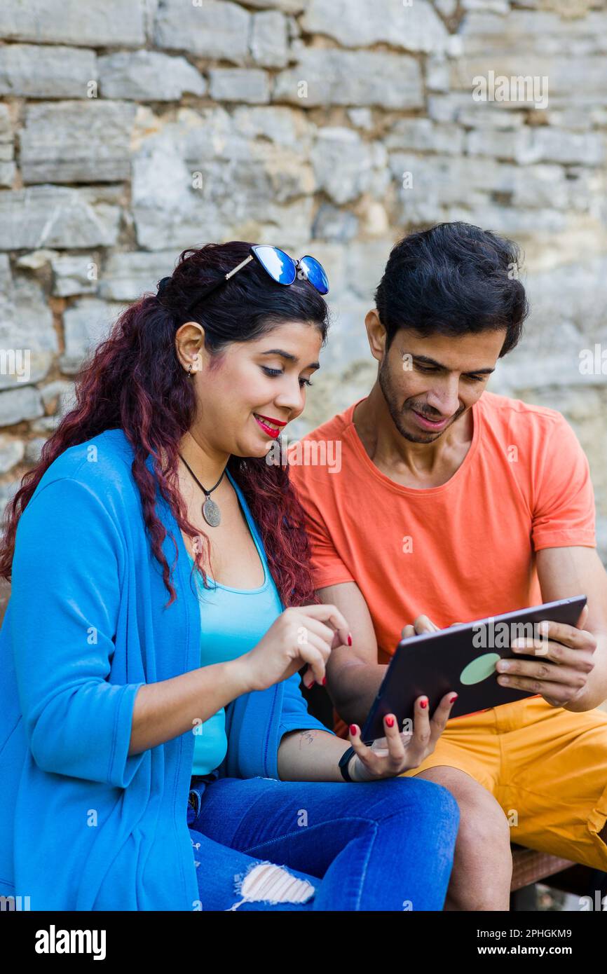 Mixed Race Couple Together In Villanueva Asturias Using Tablet
