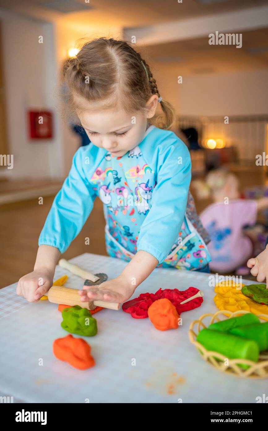 A little girl playing with plasticine. Sensory development and ...