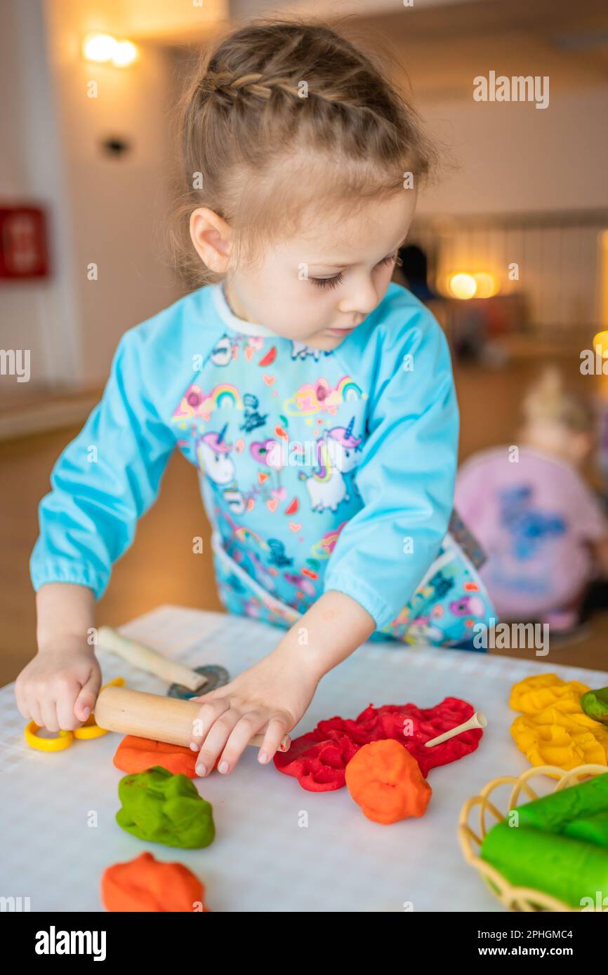 A little girl playing with plasticine. Sensory development and ...