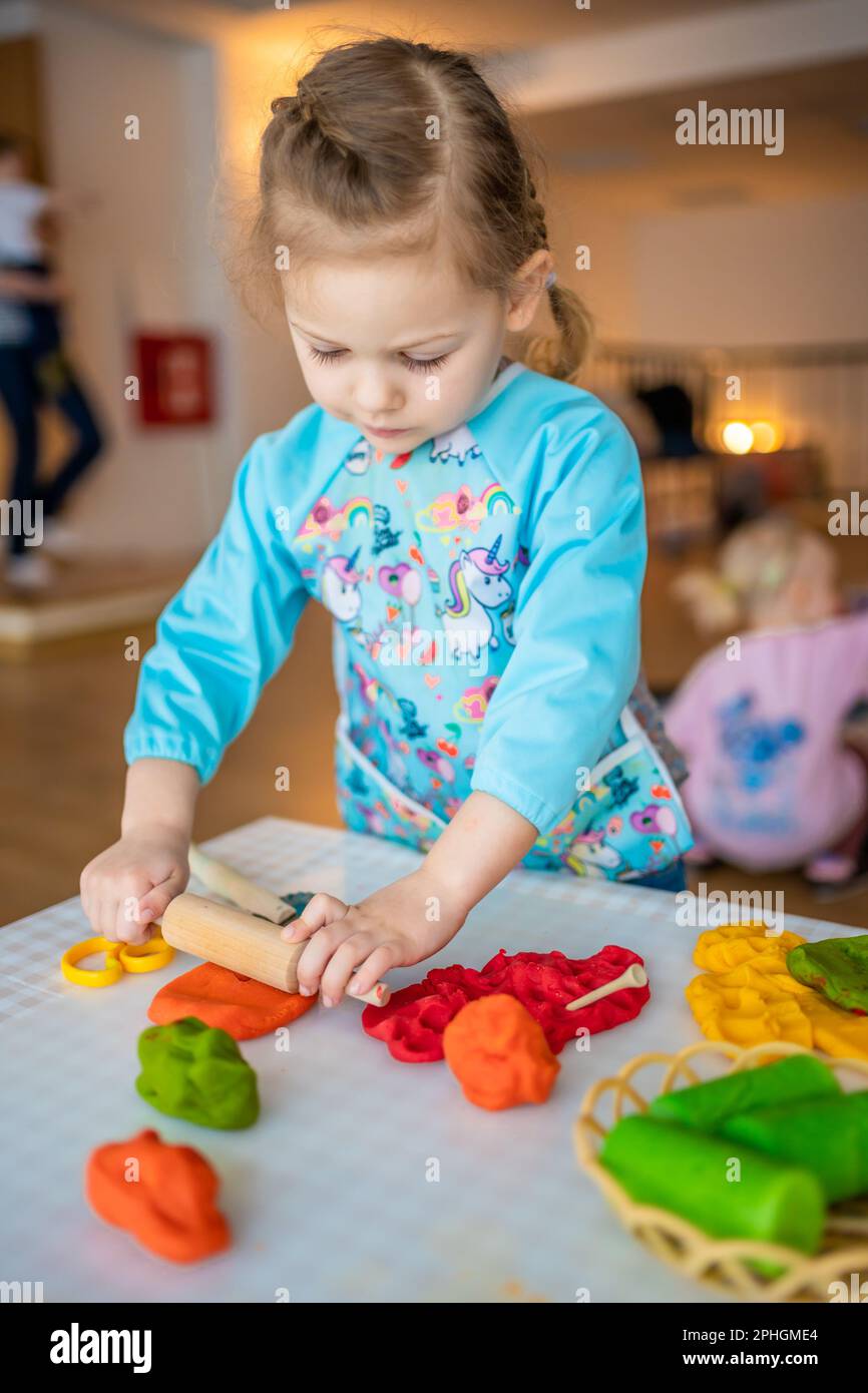 A little girl playing with plasticine. Sensory development and ...
