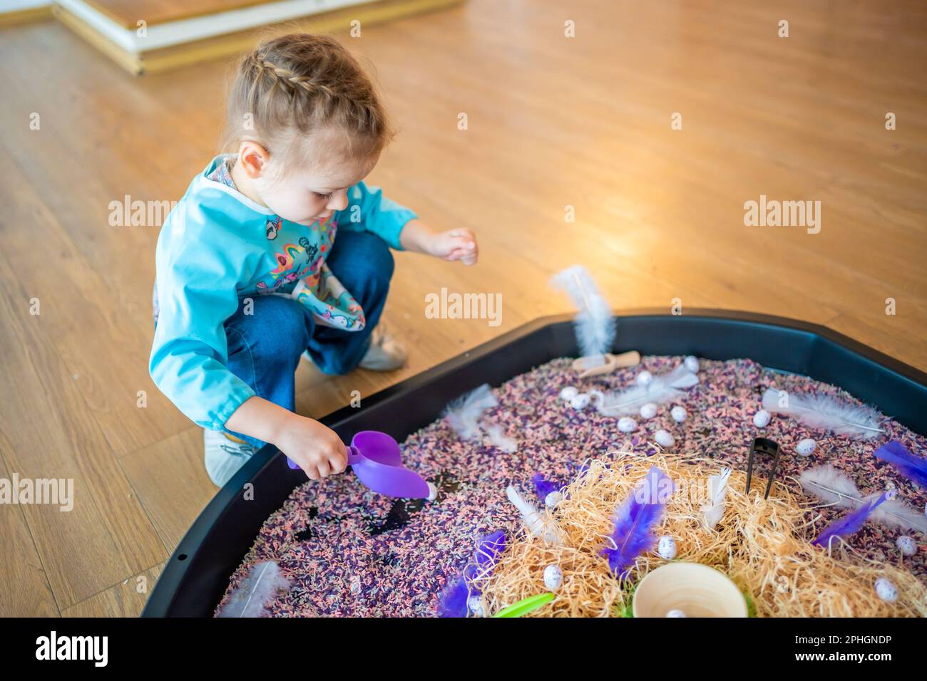 Little girl playing with sensory colorful rice. Sensory development and ...